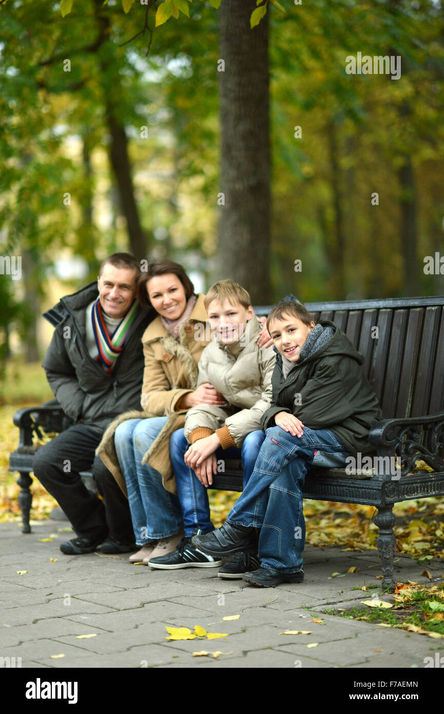 Family of four sitting Stock Photo - Alamy