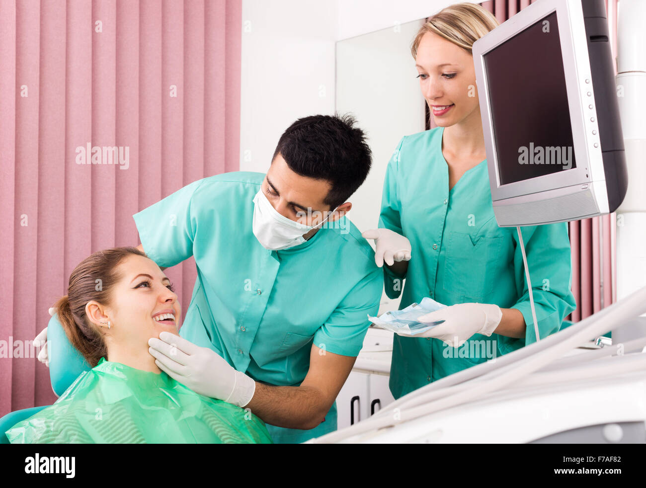 Adult doctor, assistant and patient at surgery office Stock Photo - Alamy