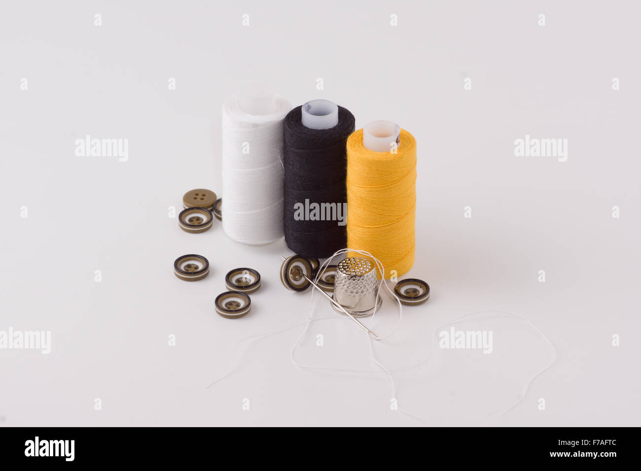 we sew buttons a sharp needle with a thread Stock Photo - Alamy