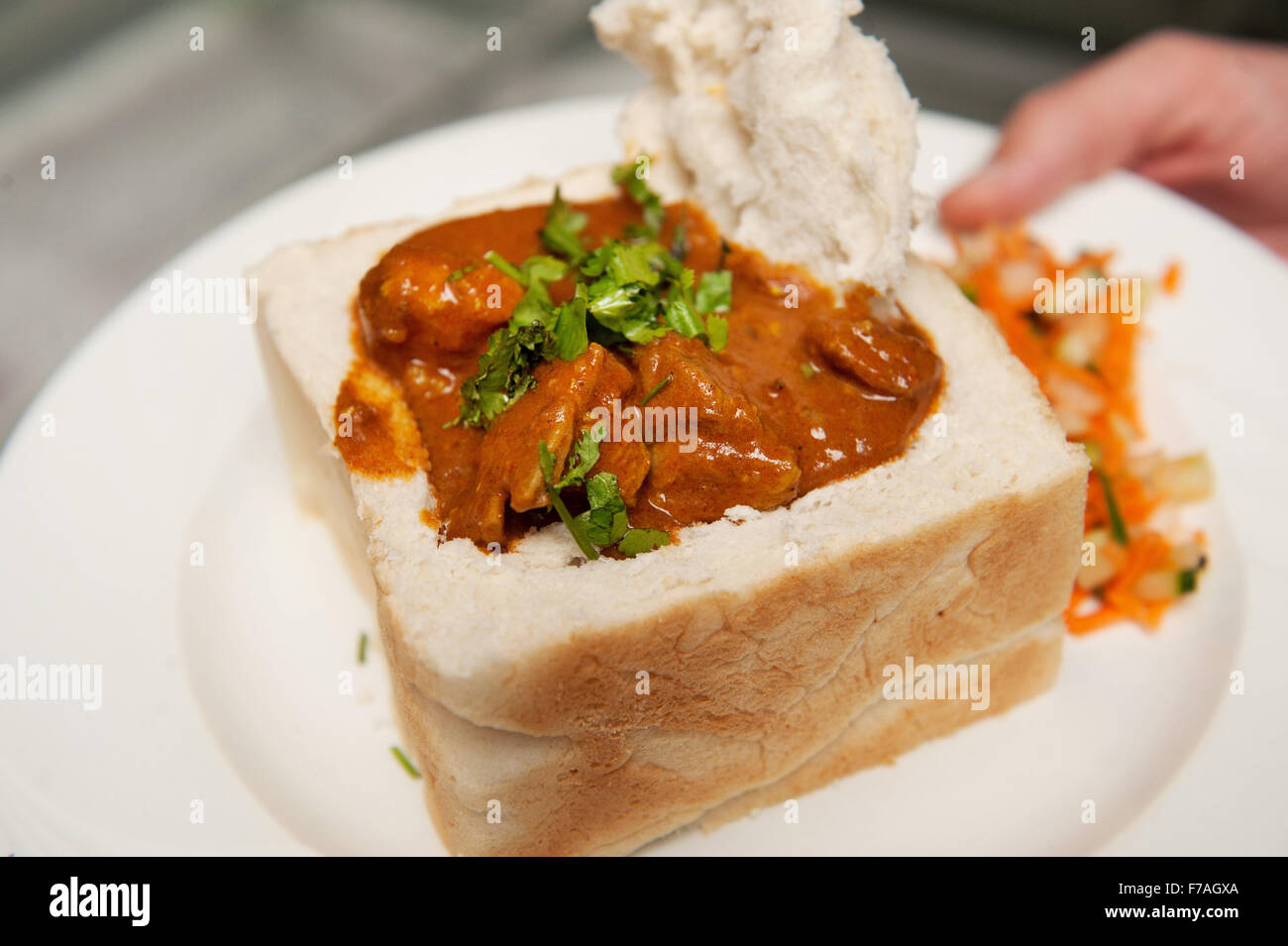 A traditional South African bunny chow, Indian curry served in a ...