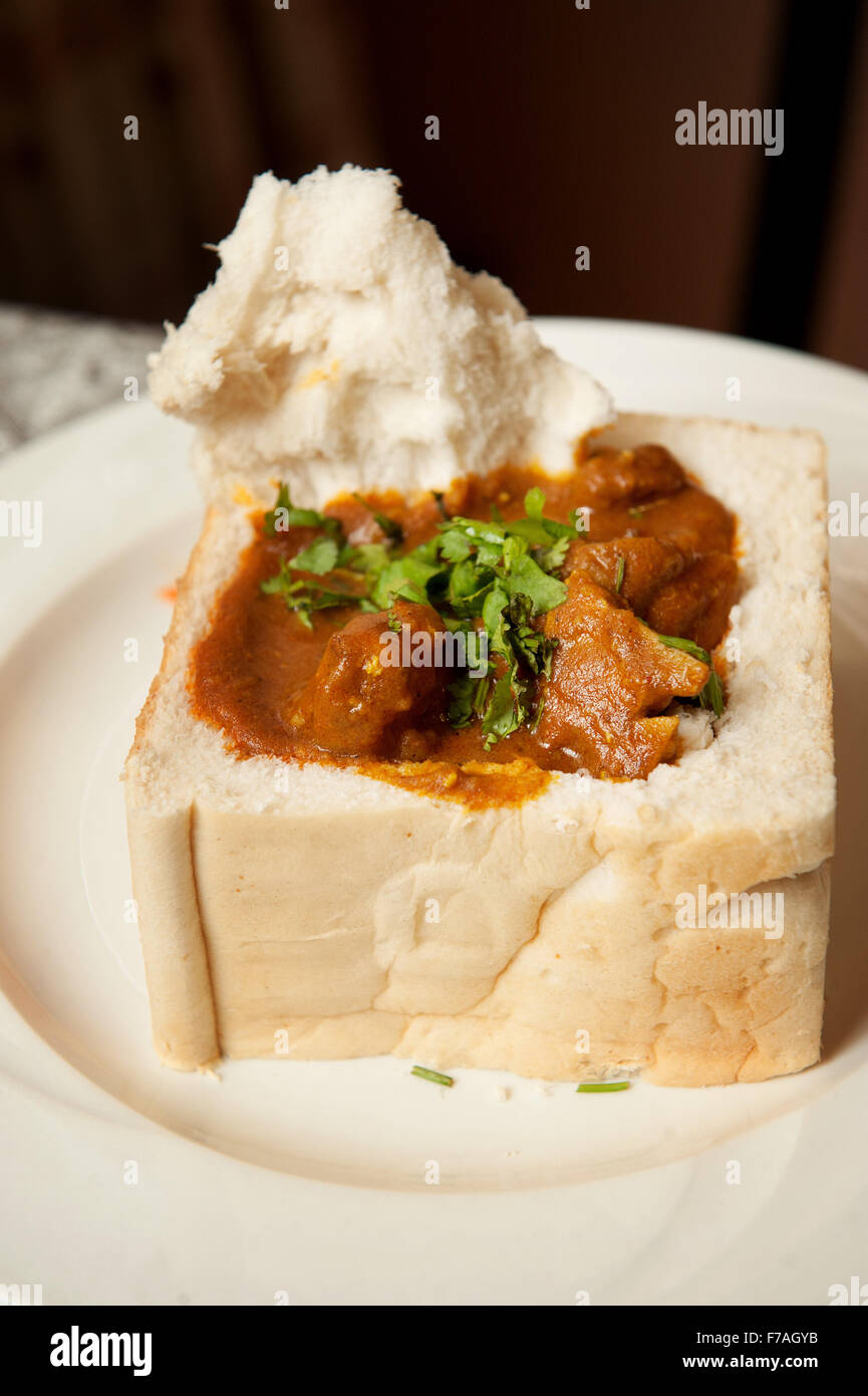 A traditional South African bunny chow, Indian curry served in a ...