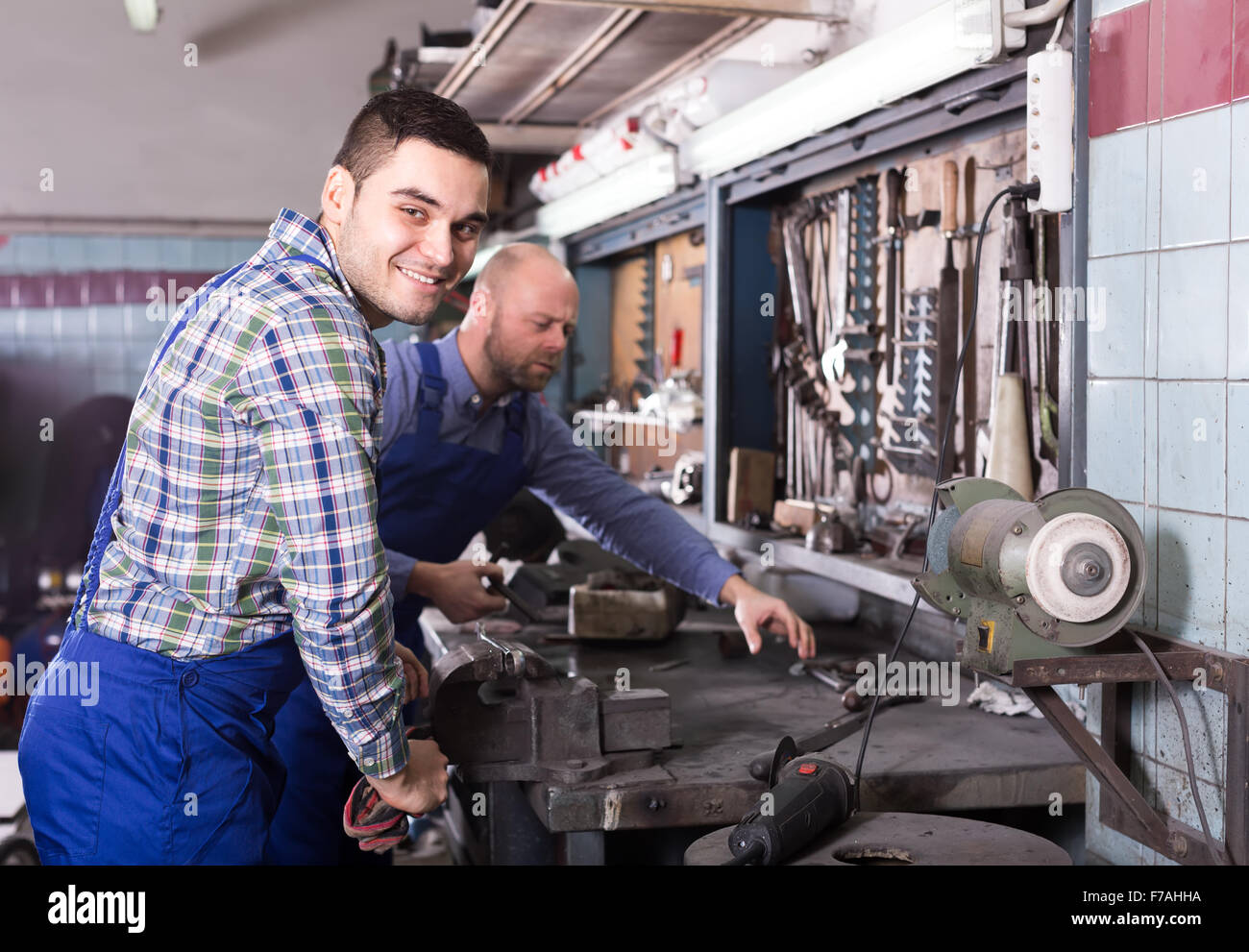 Men working with hardware in a repair shop Stock Photo - Alamy