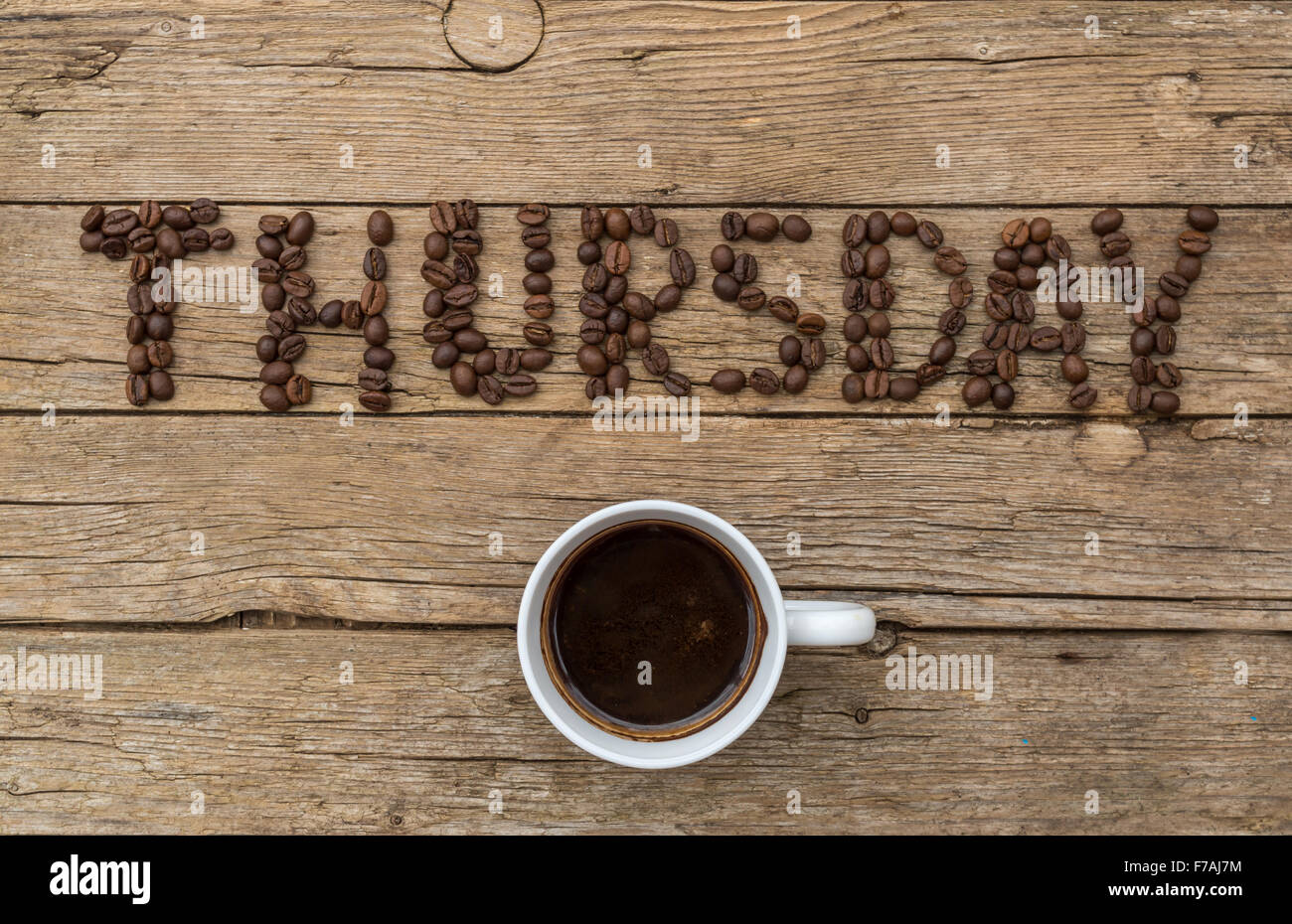 Cup of coffee on wooden background and THURSDAY coffee beans Stock ...