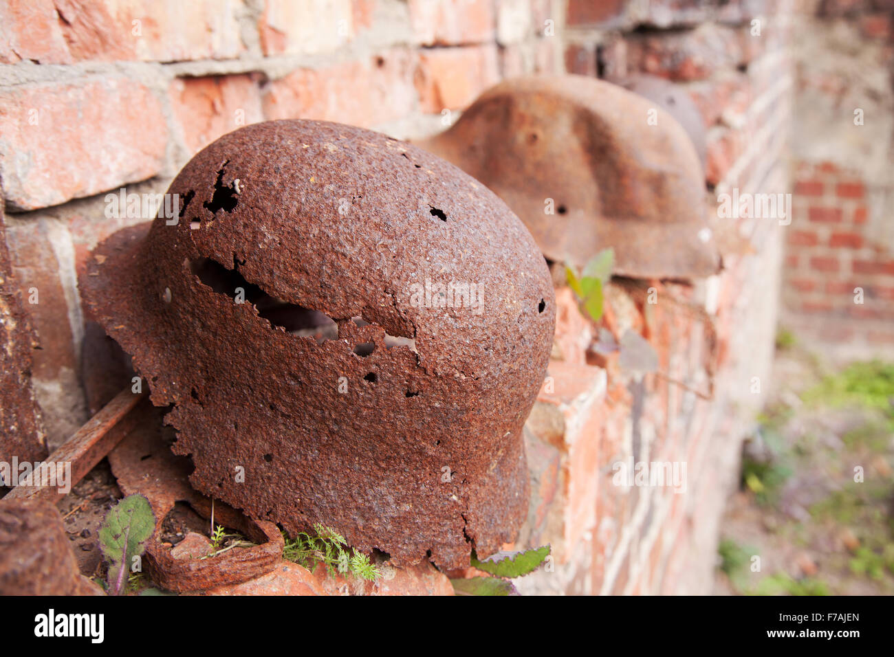 two old rusty military helmets near the brick wall Stock Photo - Alamy