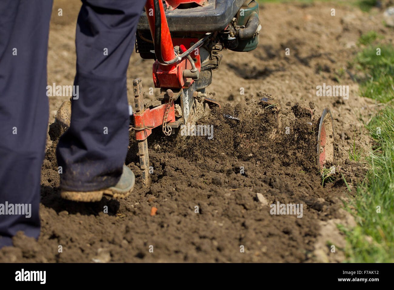 Closeup of hand motor plow blade throwing clay Stock Photo - Alamy