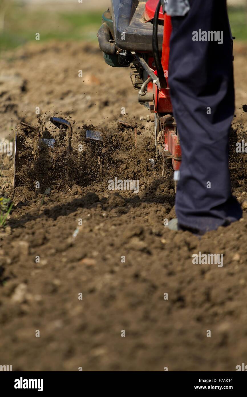 Closeup of hand motor plow blade throwing clay Stock Photo - Alamy