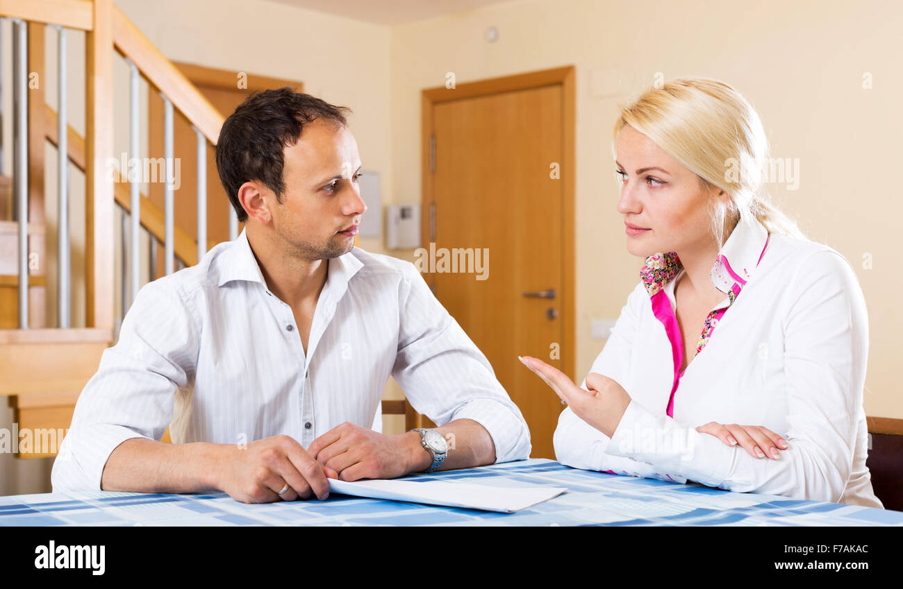 Serious young couple talking in the living room Stock Photo - Alamy