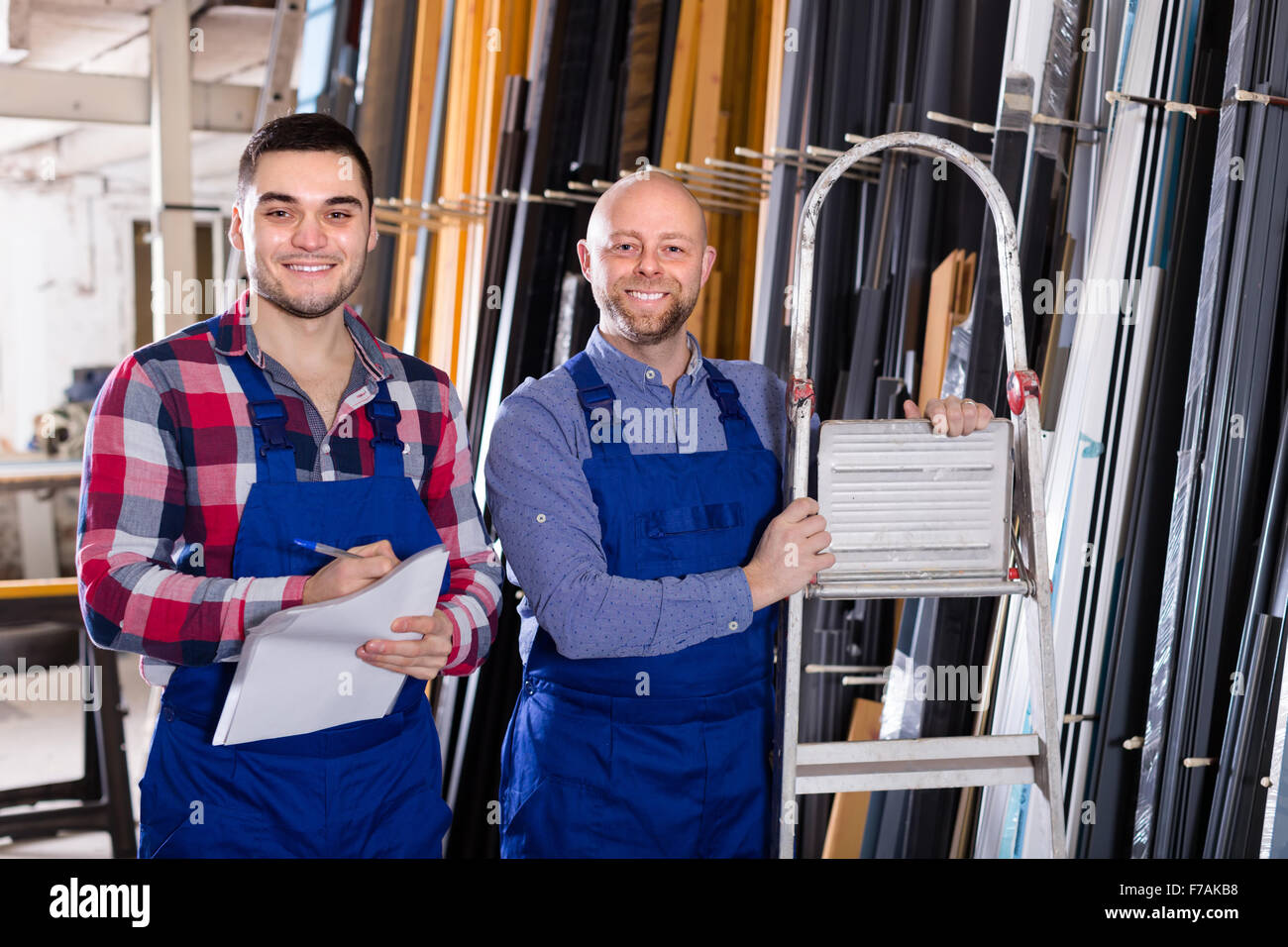 Two production workers in coverall with different PVC window Stock ...