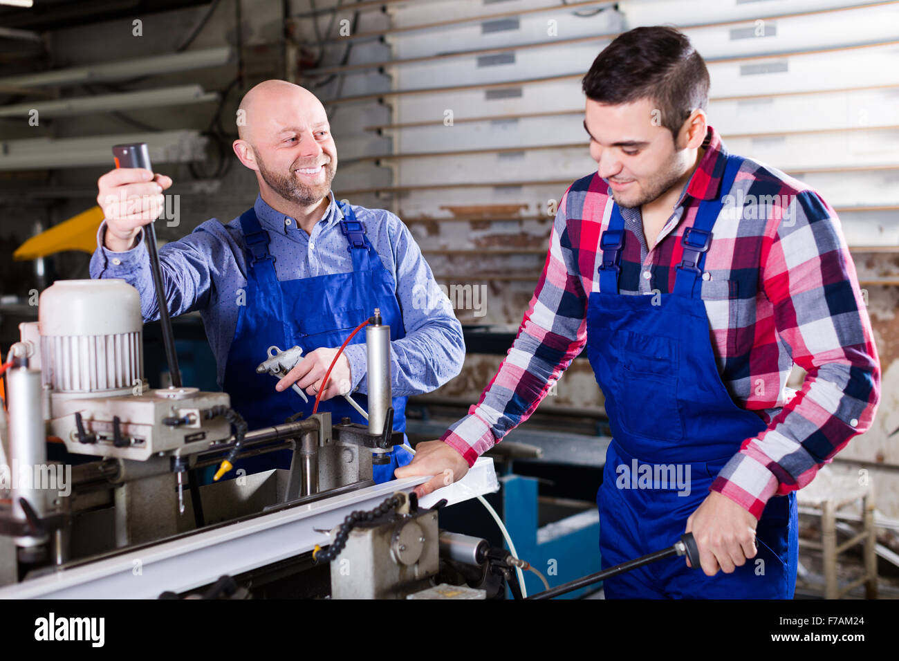 Couple of professional workers near milling machine at factory Stock ...