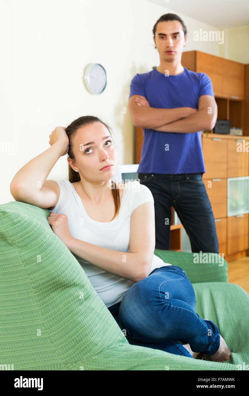 Family quarrel. Upset family after conflict on sofa at home. Focus on ...