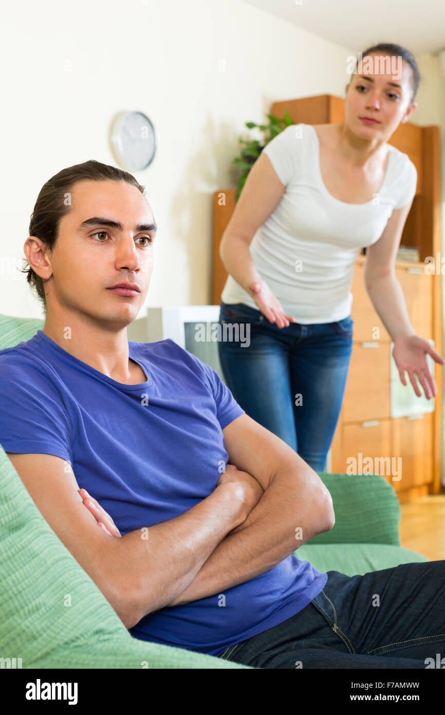 Couple conflict. Portrait of young couple after quarrel in living room ...