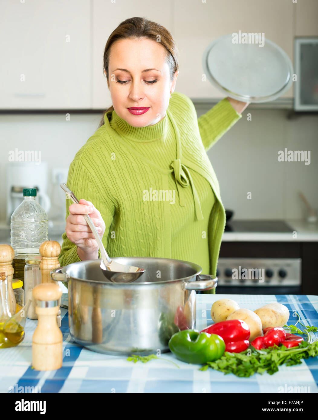 Attractive woman cooking healthy and tasty vegetable soup Stock Photo ...