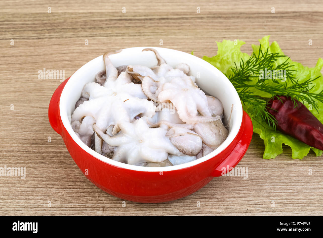 Raw baby octopus in the bowl ready for cooking Stock Photo - Alamy