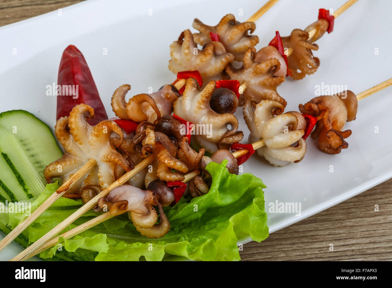 Grilled octopus skewers with red pepper and onion Stock Photo - Alamy