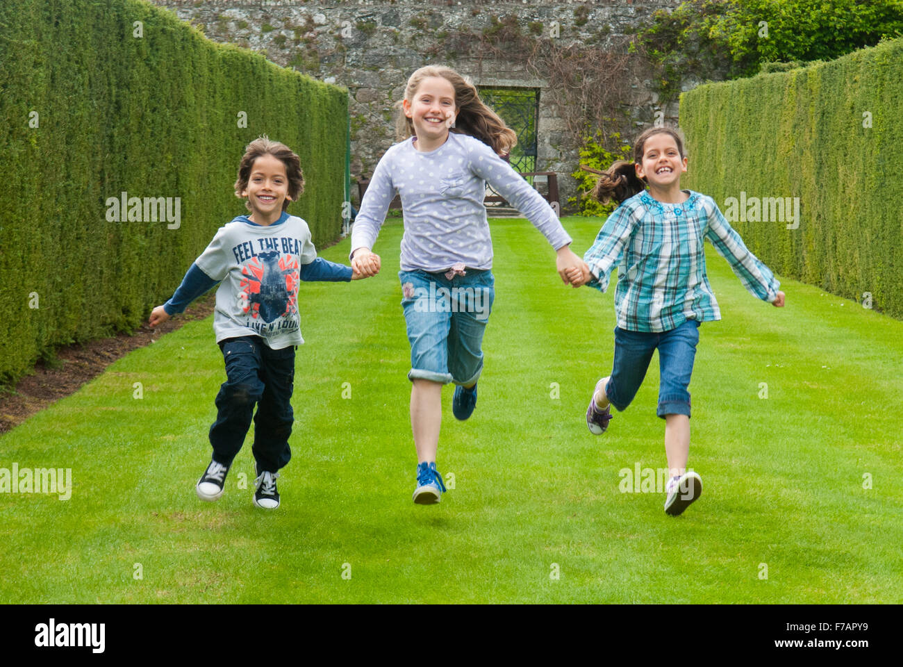 Three children running along the grass at the Rose Gardens at Drum ...