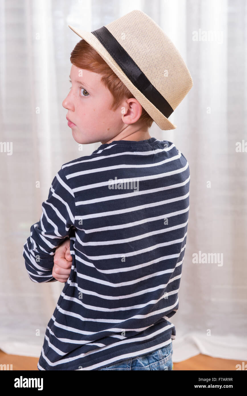 young boy with hat looking over his shoulder Stock Photo - Alamy