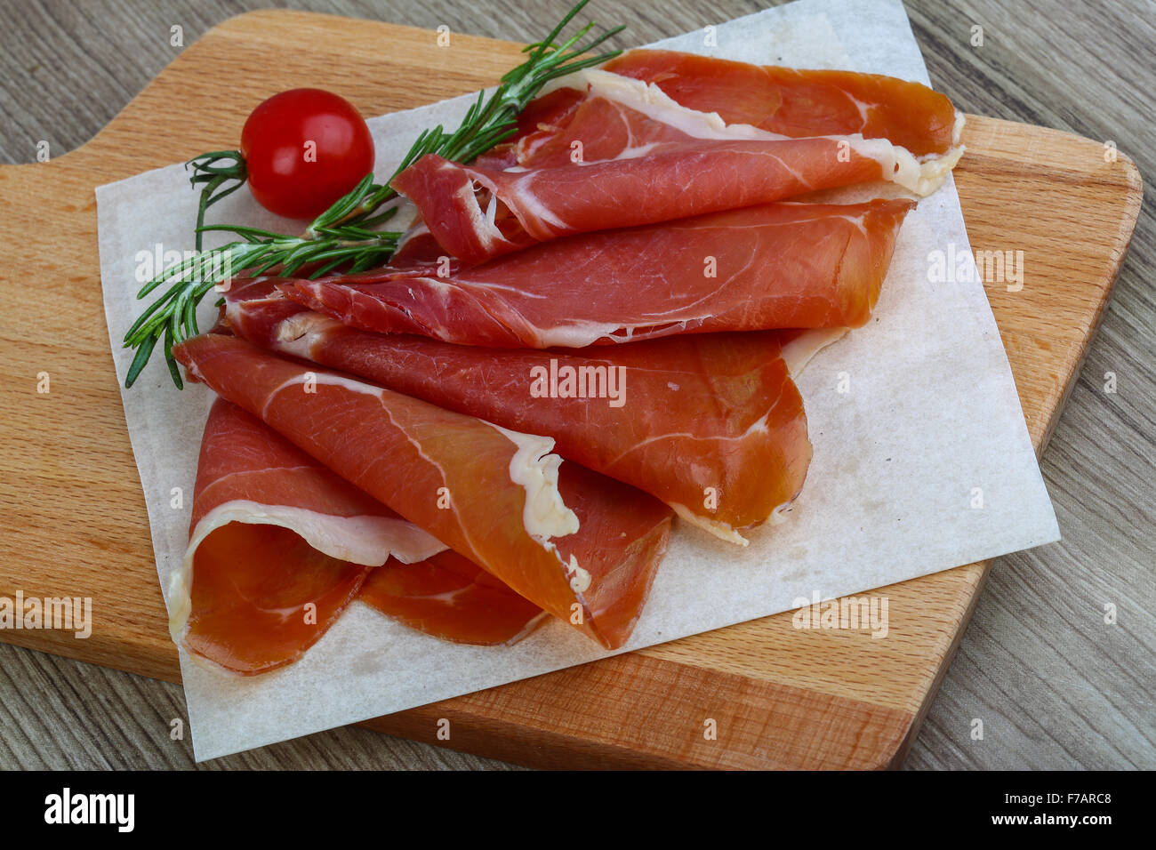 Spanish traditional snack - Jamon with tomato and rosemary Stock Photo ...