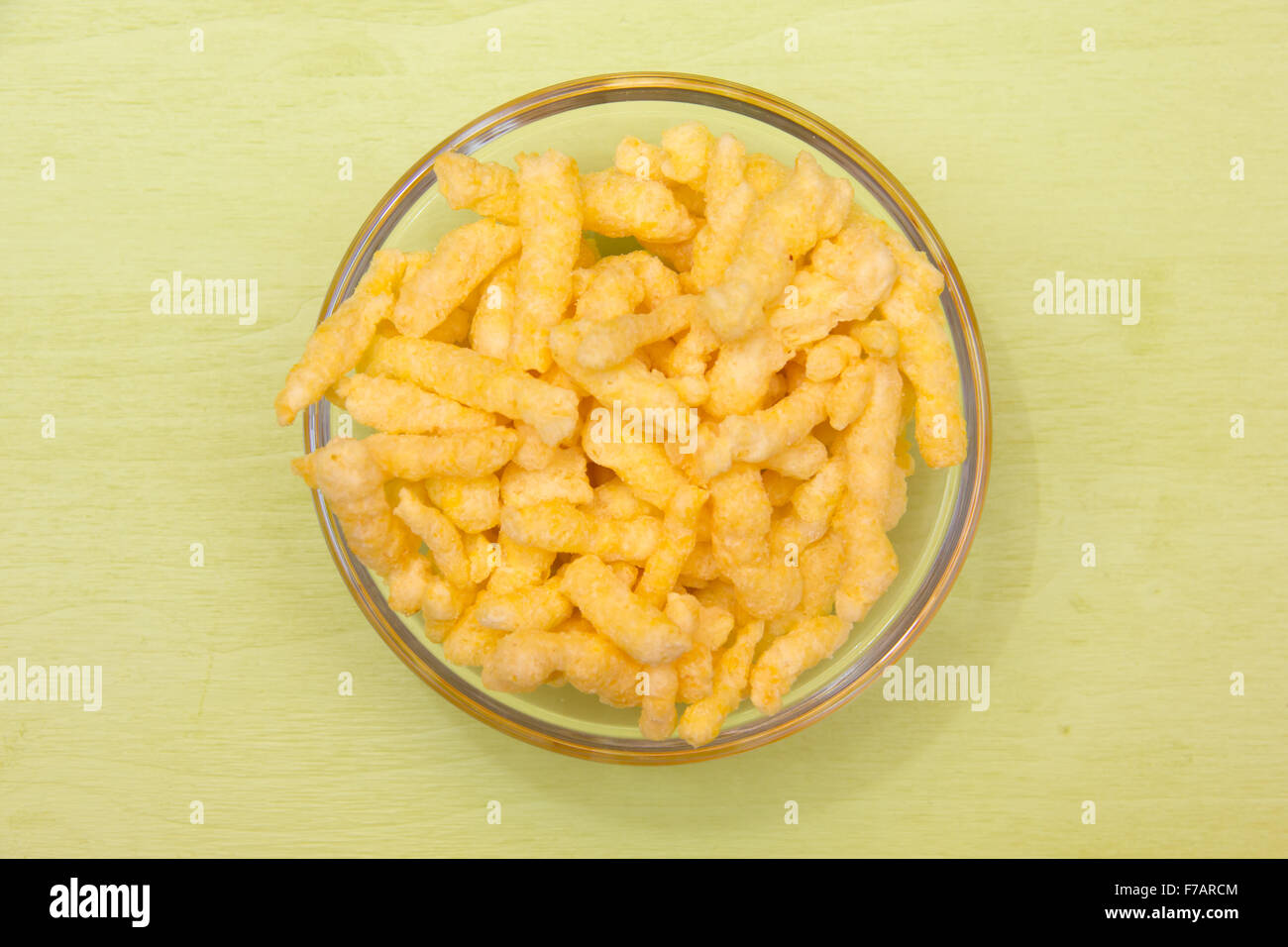 Snack corn cheese in bowl on green table top view Stock Photo - Alamy