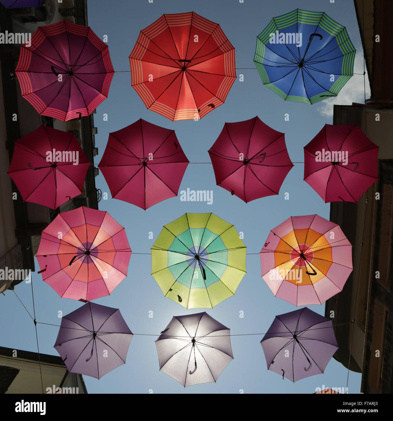 Colored parasols in the streets of Iglesias, Sardinia, Italy Stock ...