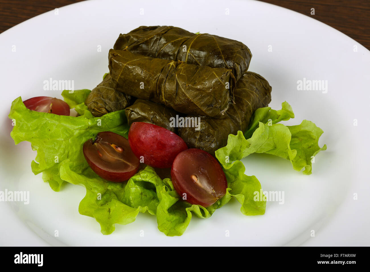 Dolma - minced meat in grape leaves with salad Stock Photo - Alamy