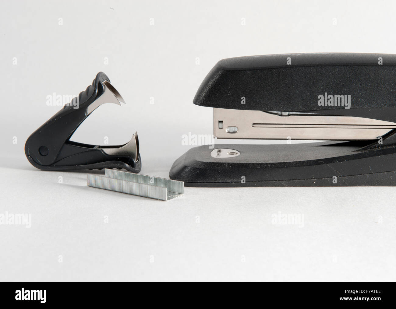 Stapler, staples and staple remover against a white background Stock ...