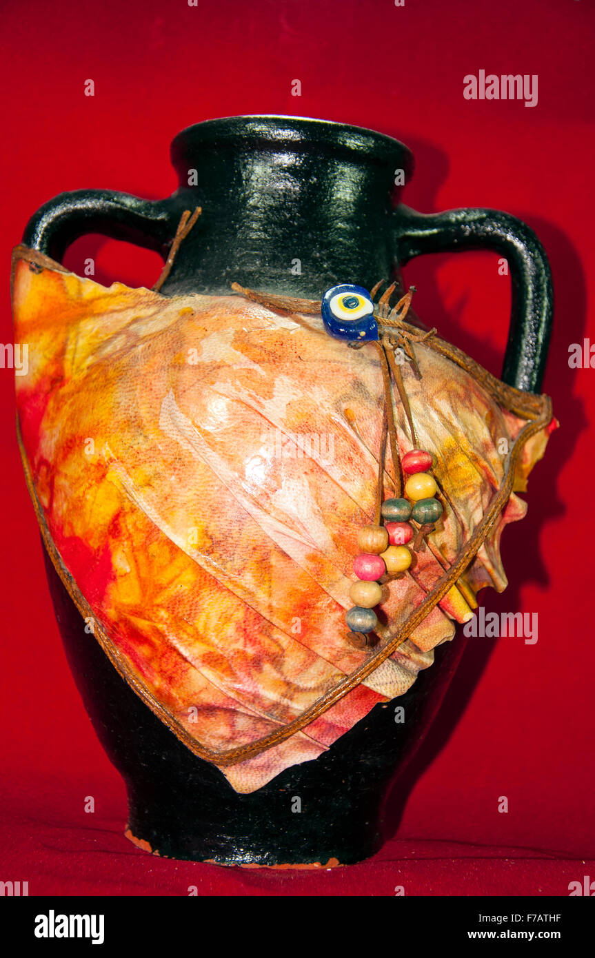Black color ancient jug on a red background Stock Photo - Alamy