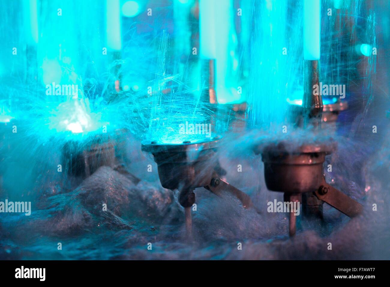 Water splashing on blue lights in a fountain Stock Photo - Alamy