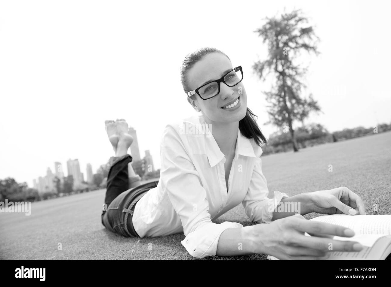 Beautiful girl reading book park Black and White Stock Photos & Images ...