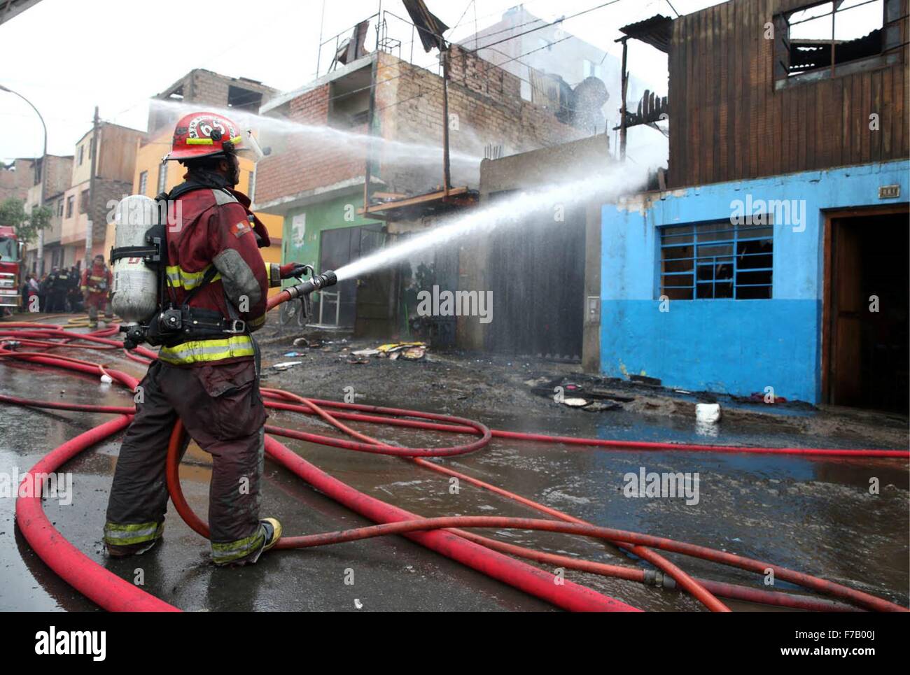 Lima, Peru. 27th Nov, 2015. A fireman works at the scene of a fire in ...