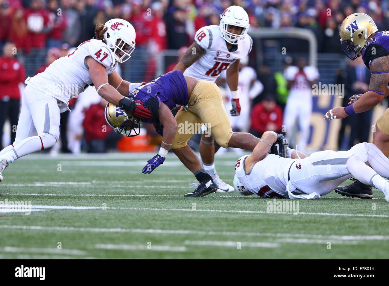 November 27, 2015: Washington's Myles Gaskin (9) is pulled in two ...