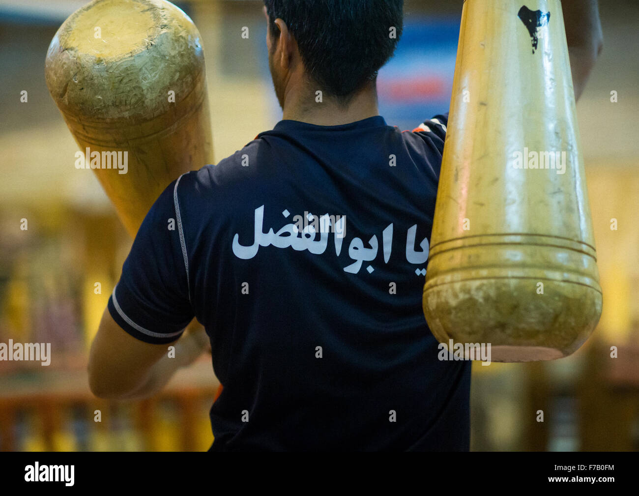 Iranian Man Wielding Wooden Clubs During The Traditional Sport Of ...