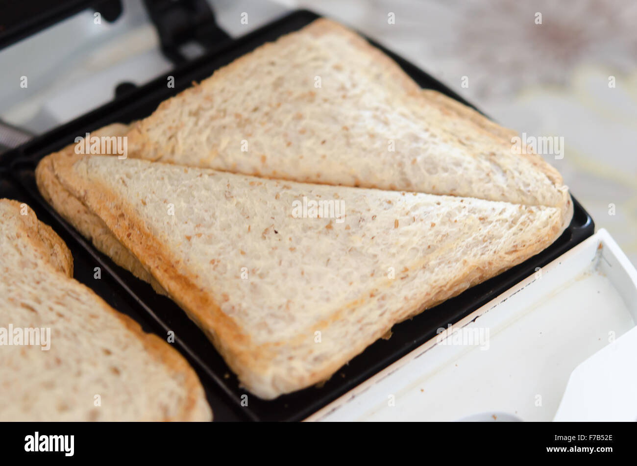 toasts the bread on the grill Stock Photo - Alamy
