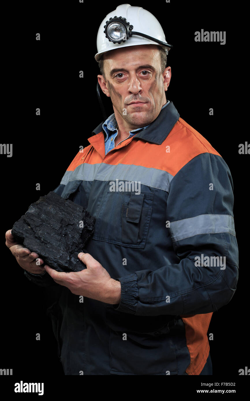 Coal miner showing lump of coal Stock Photo - Alamy
