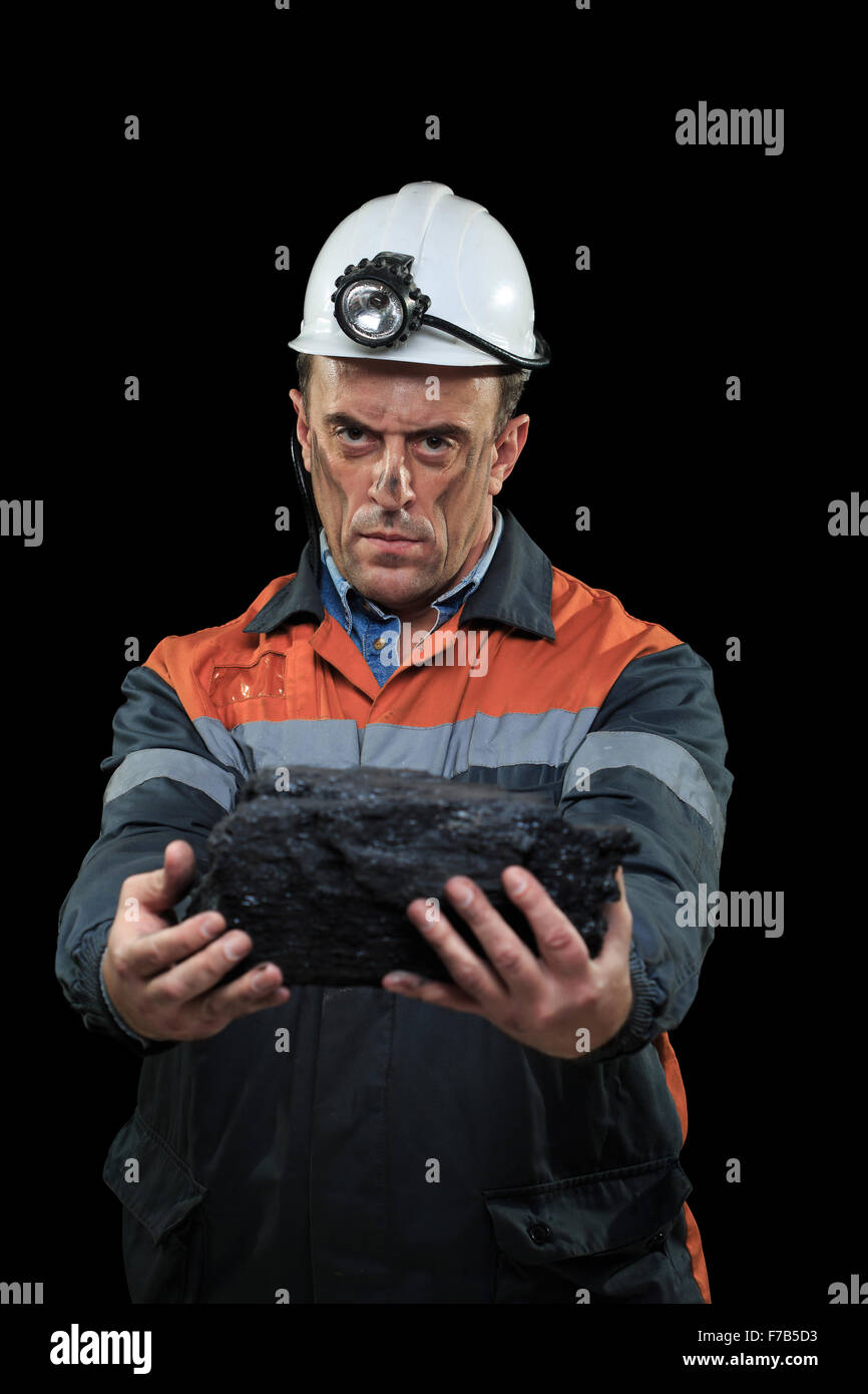 Coal miner showing lump of coal Stock Photo - Alamy