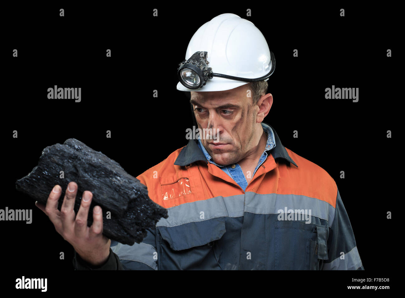 Coal miner showing lump of coal Stock Photo - Alamy