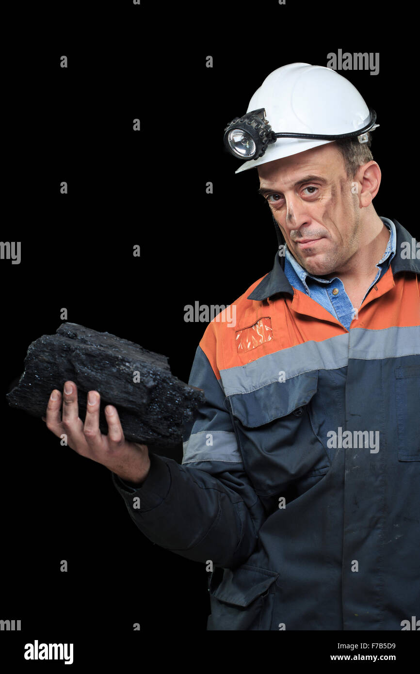 Coal miner showing lump of coal Stock Photo - Alamy