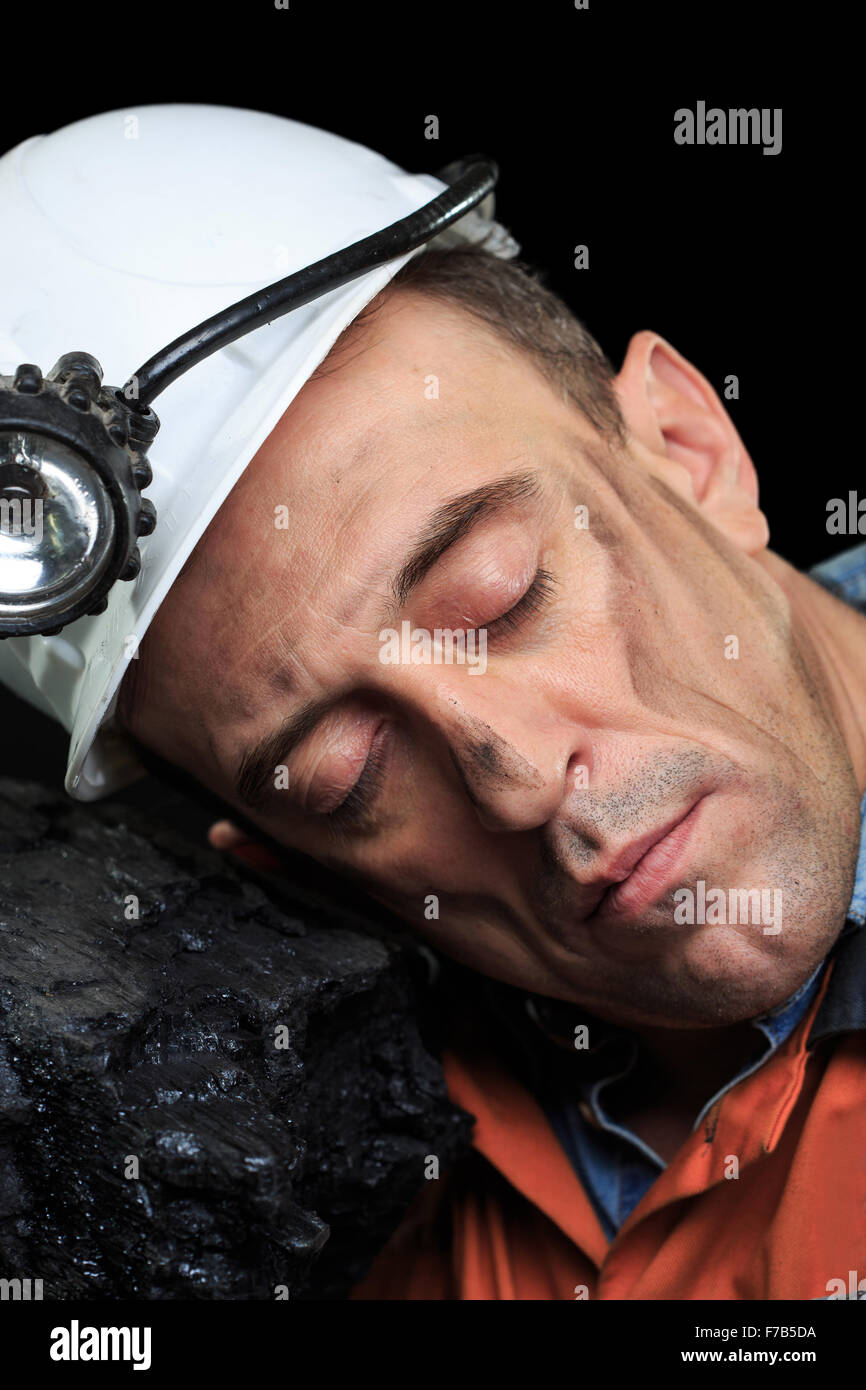Coal miner showing lump of coal Stock Photo - Alamy