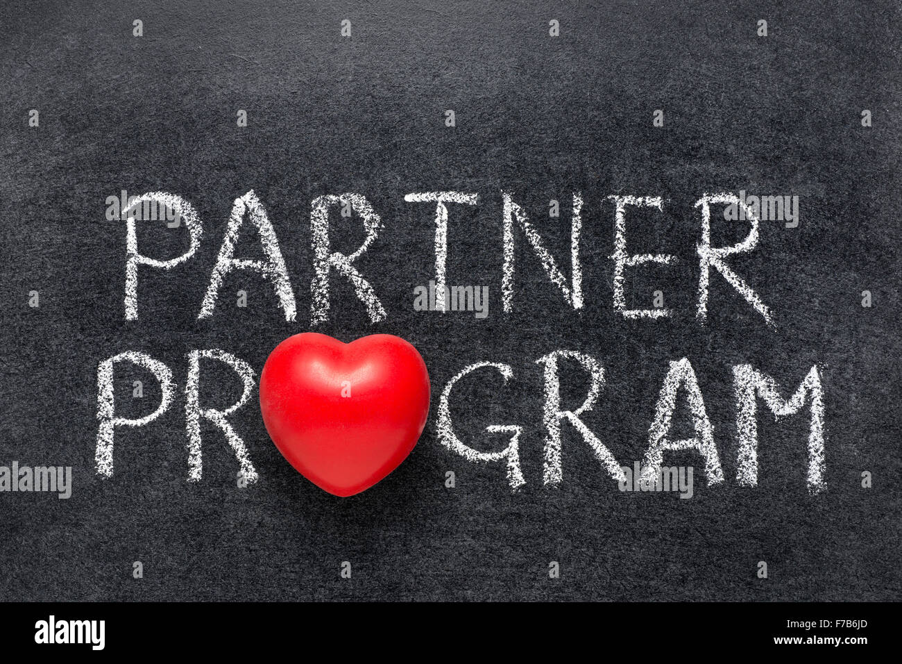 partner program phrase handwritten on blackboard with heart symbol ...