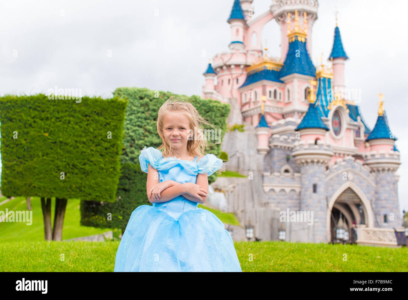 Little happy girl in princess dress at fairy-tale park Disneyland Stock ...