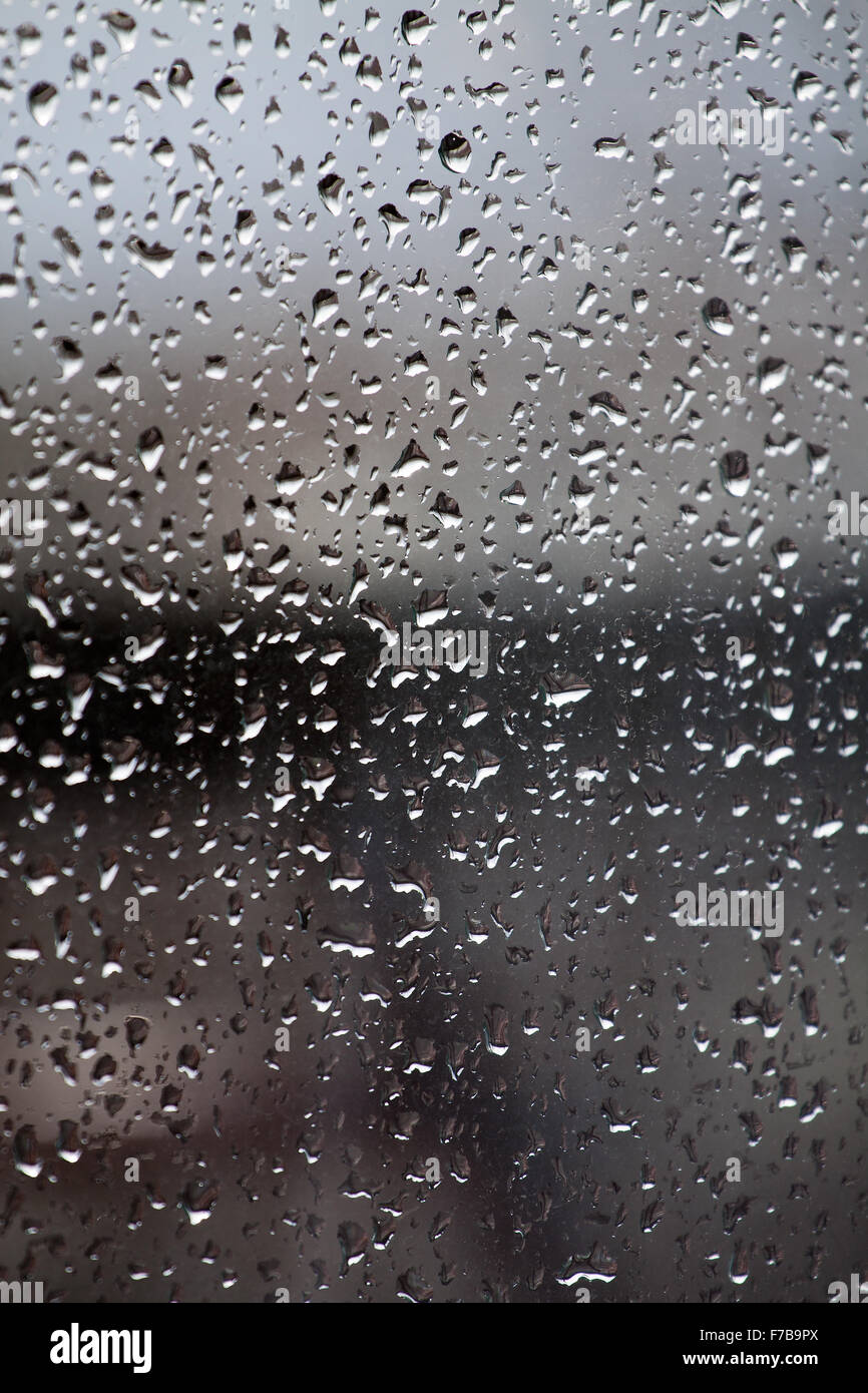 Raindrops on the surface of the dusty window Stock Photo - Alamy