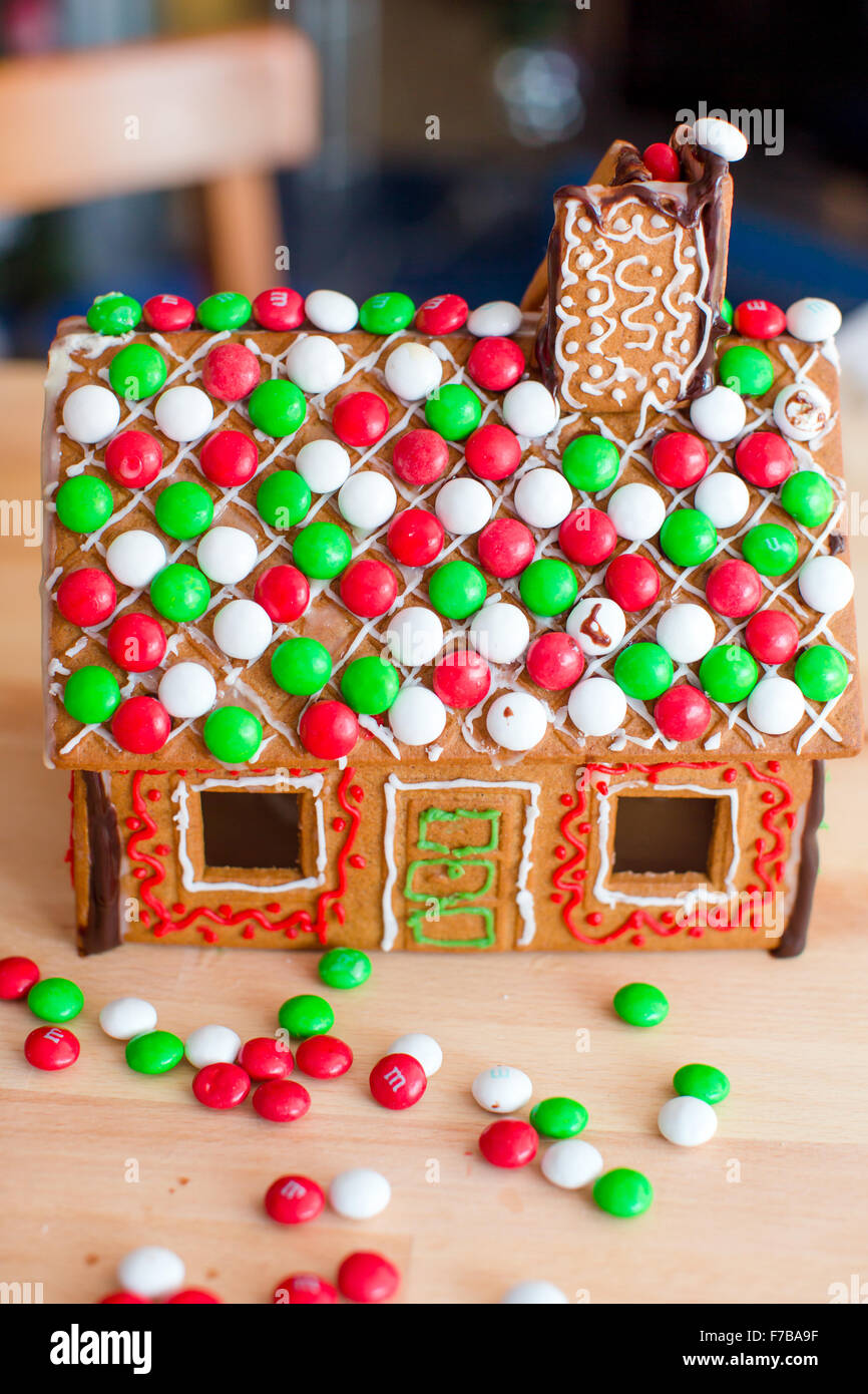 Gingerbread fairy house on a background of bright Christmas tree with ...