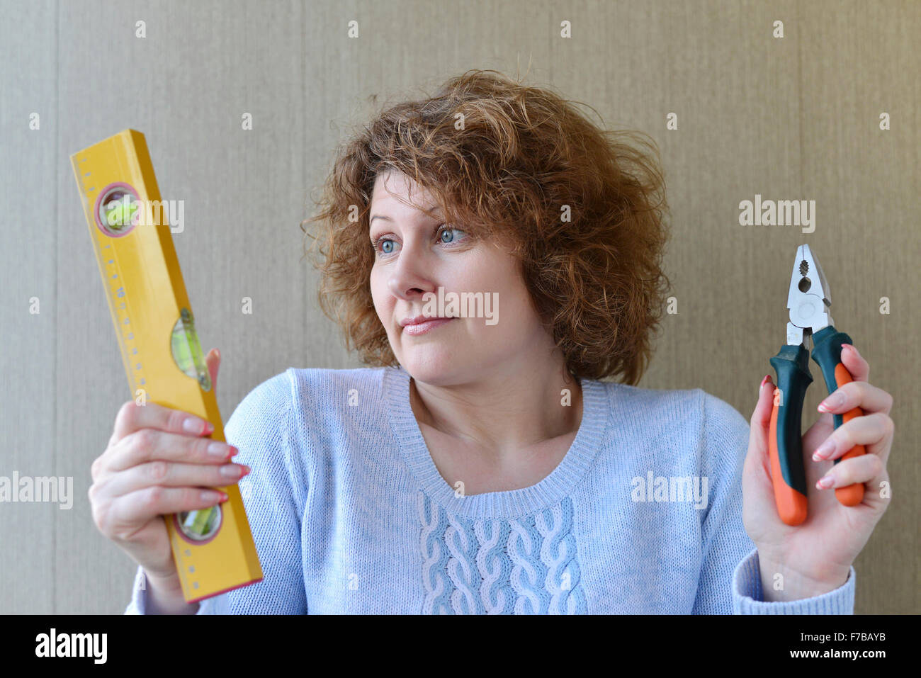 woman is holding construction tools Stock Photo - Alamy