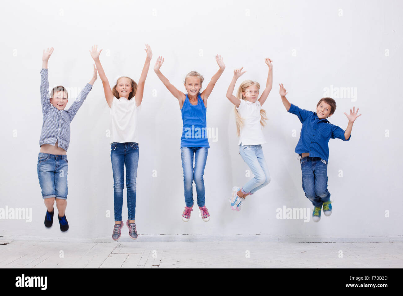 Group of happy young people jumping on white background Stock Photo - Alamy