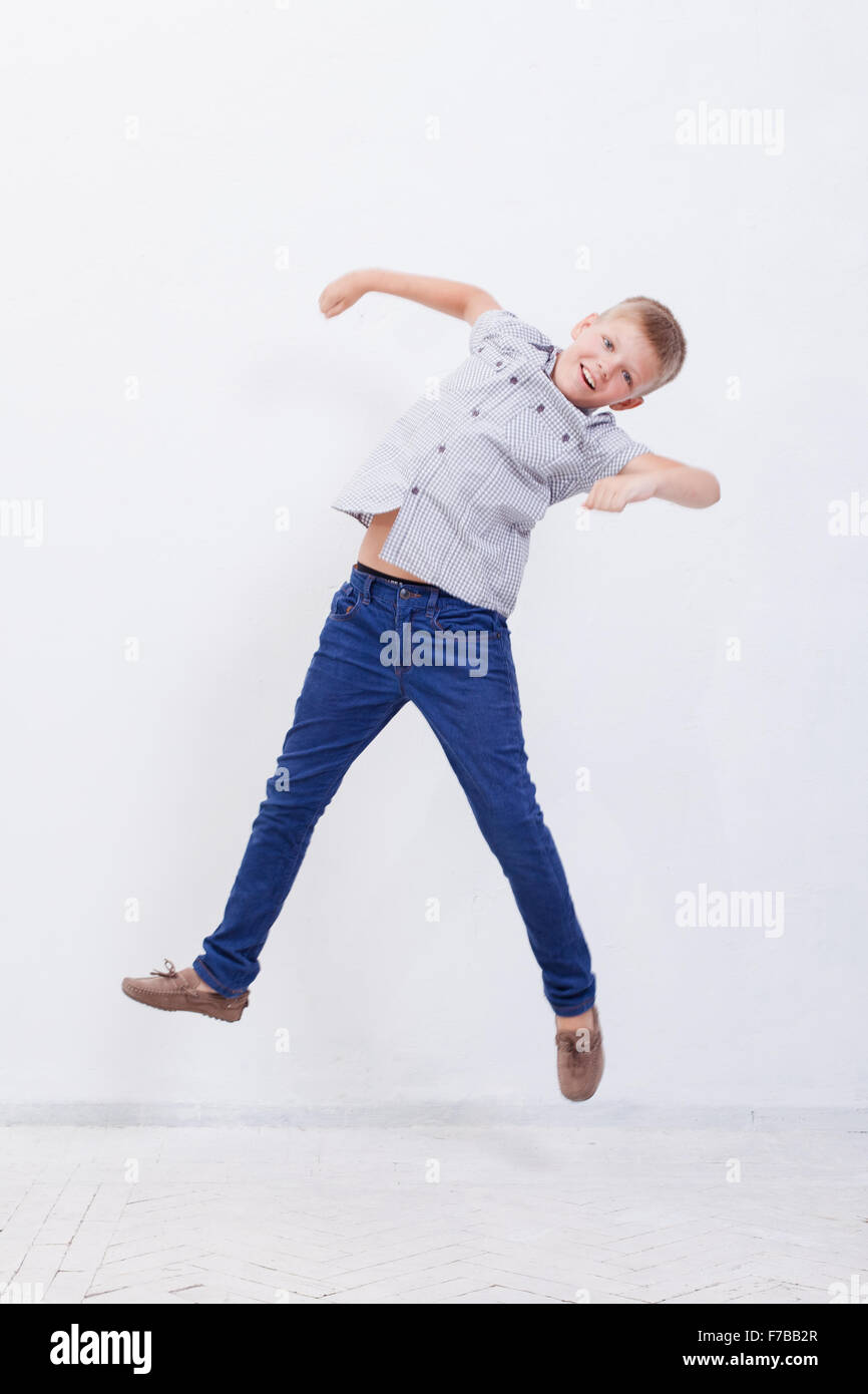 happy young boy jumping on white background Stock Photo - Alamy