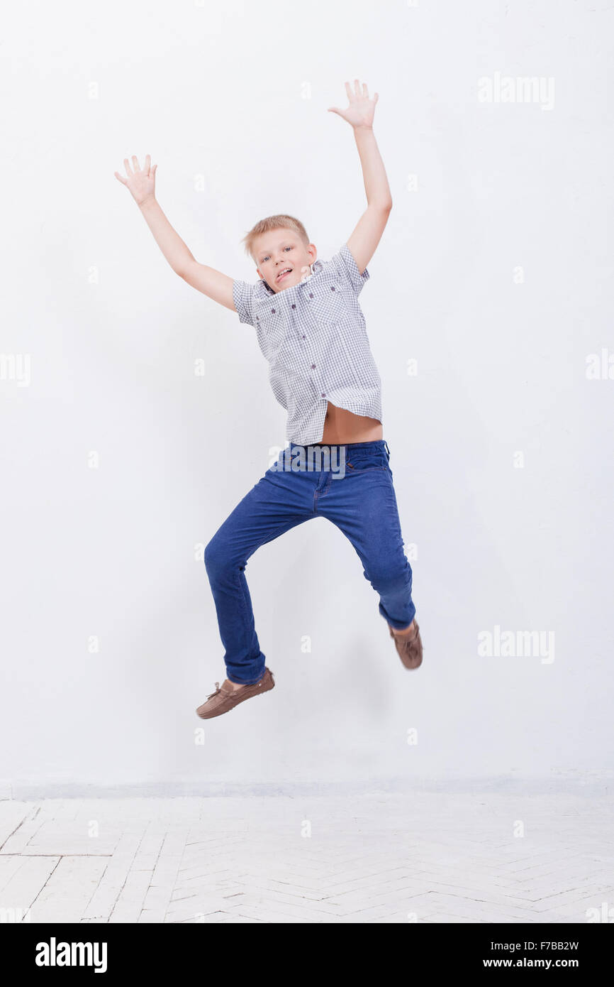 happy young boy jumping on white background Stock Photo - Alamy