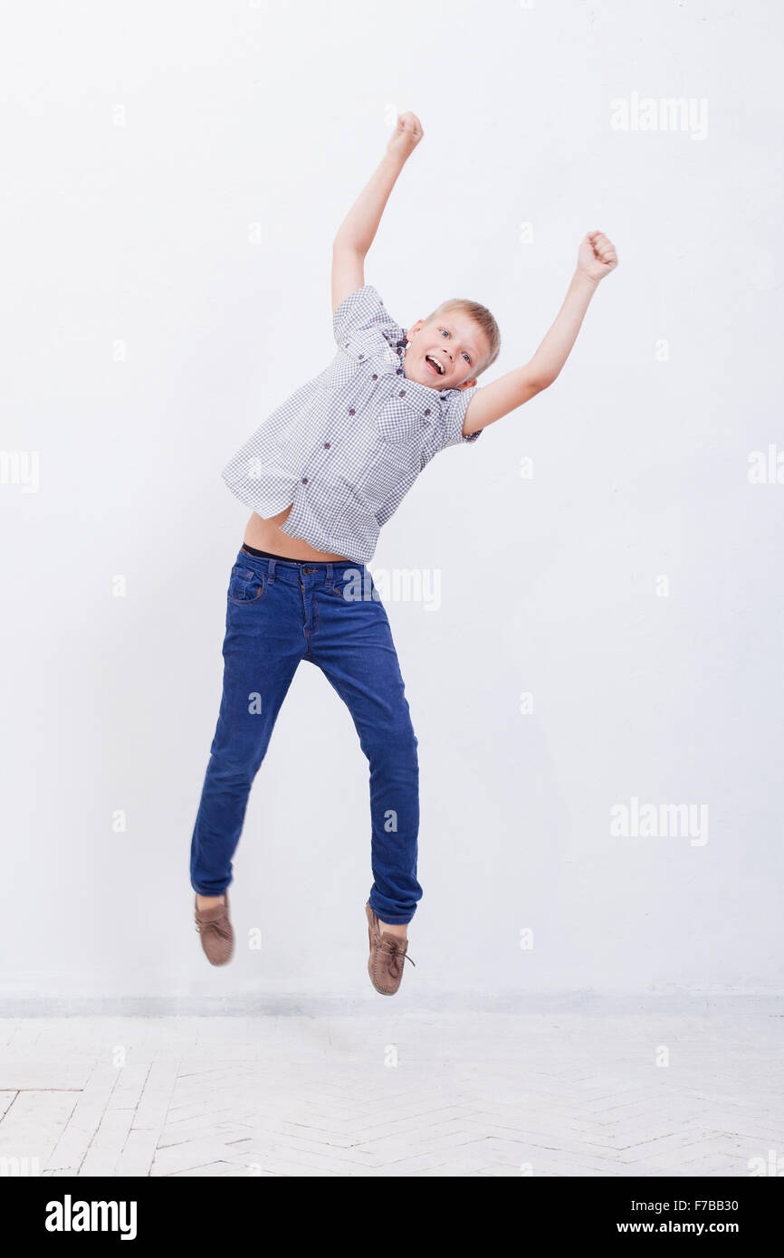 happy young boy jumping on white background Stock Photo - Alamy