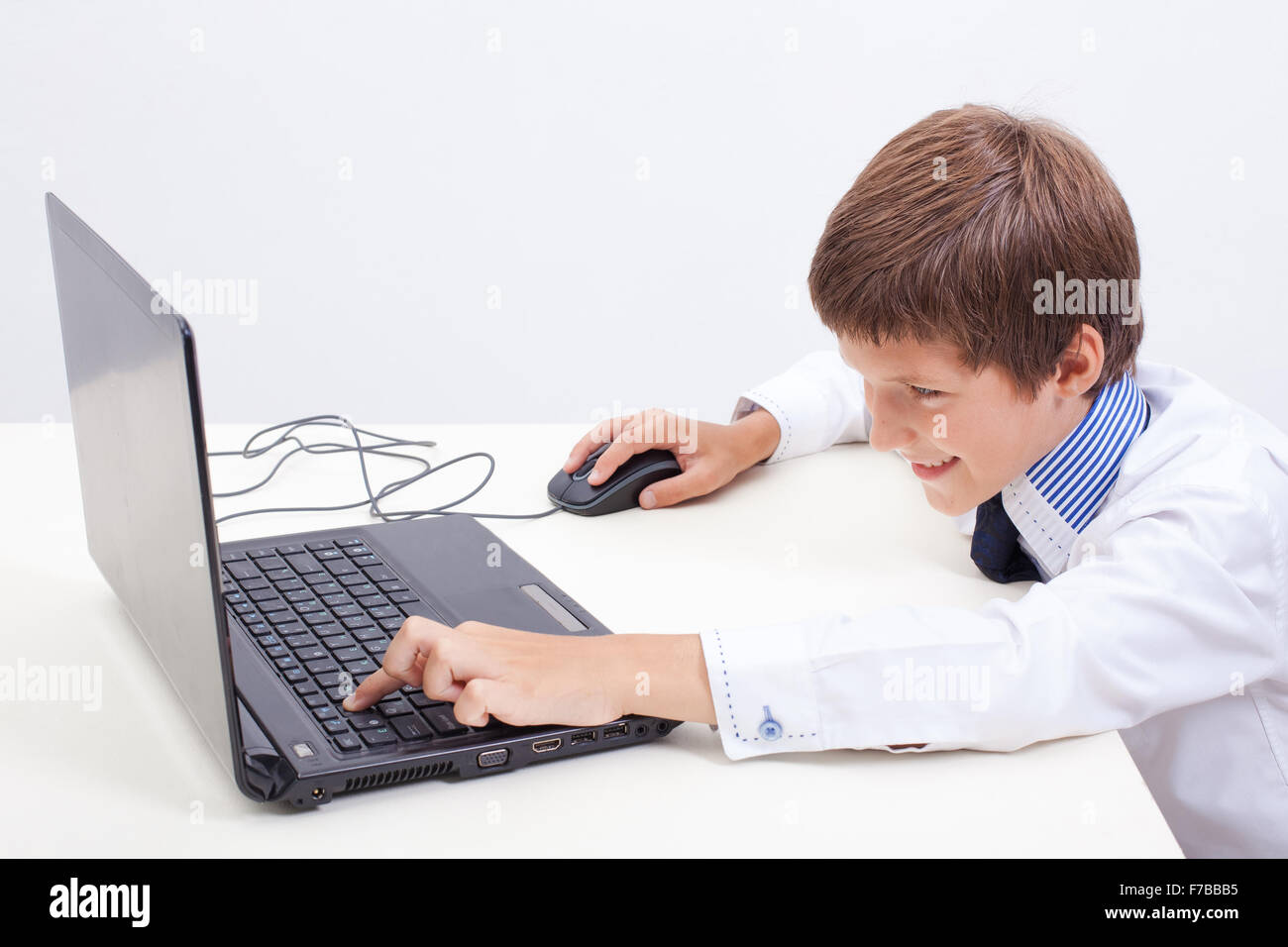Boy using his laptop computer Stock Photo - Alamy