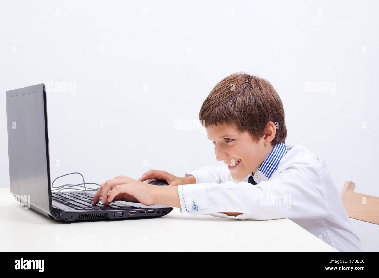 Boy using his laptop computer Stock Photo - Alamy