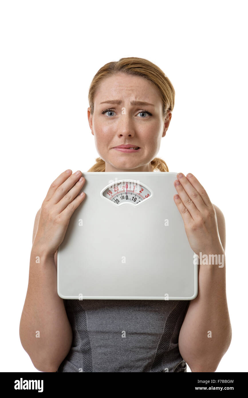 fitness woman holding scale unsure and afraid to weight herself Stock ...