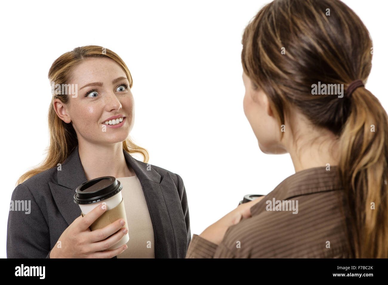 Two business woman chatting and enjoying a gossip over a coffee ...